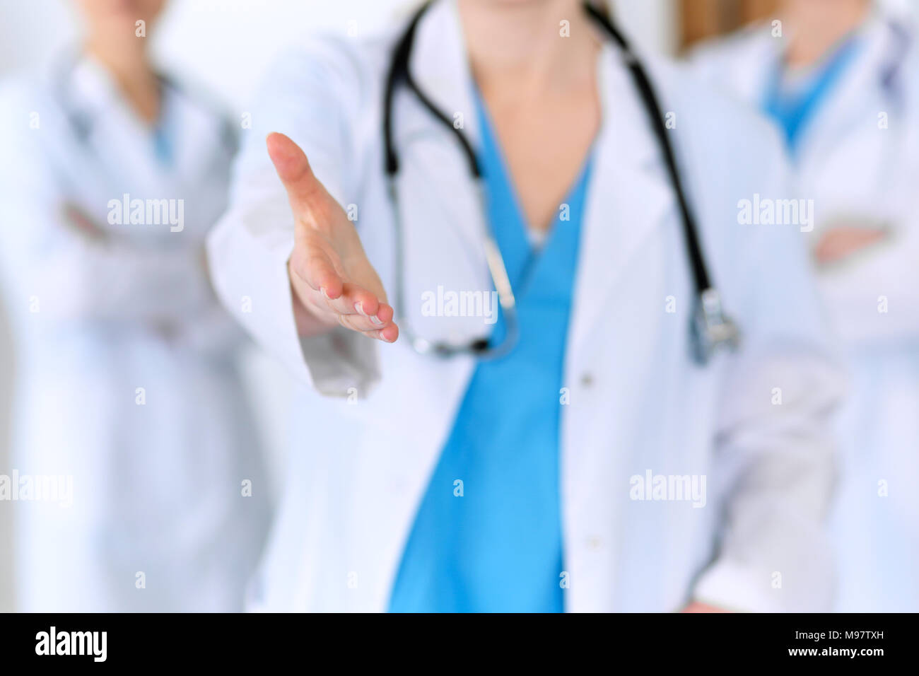 Group of medicine doctors offering helping hand for shaking hand or ...