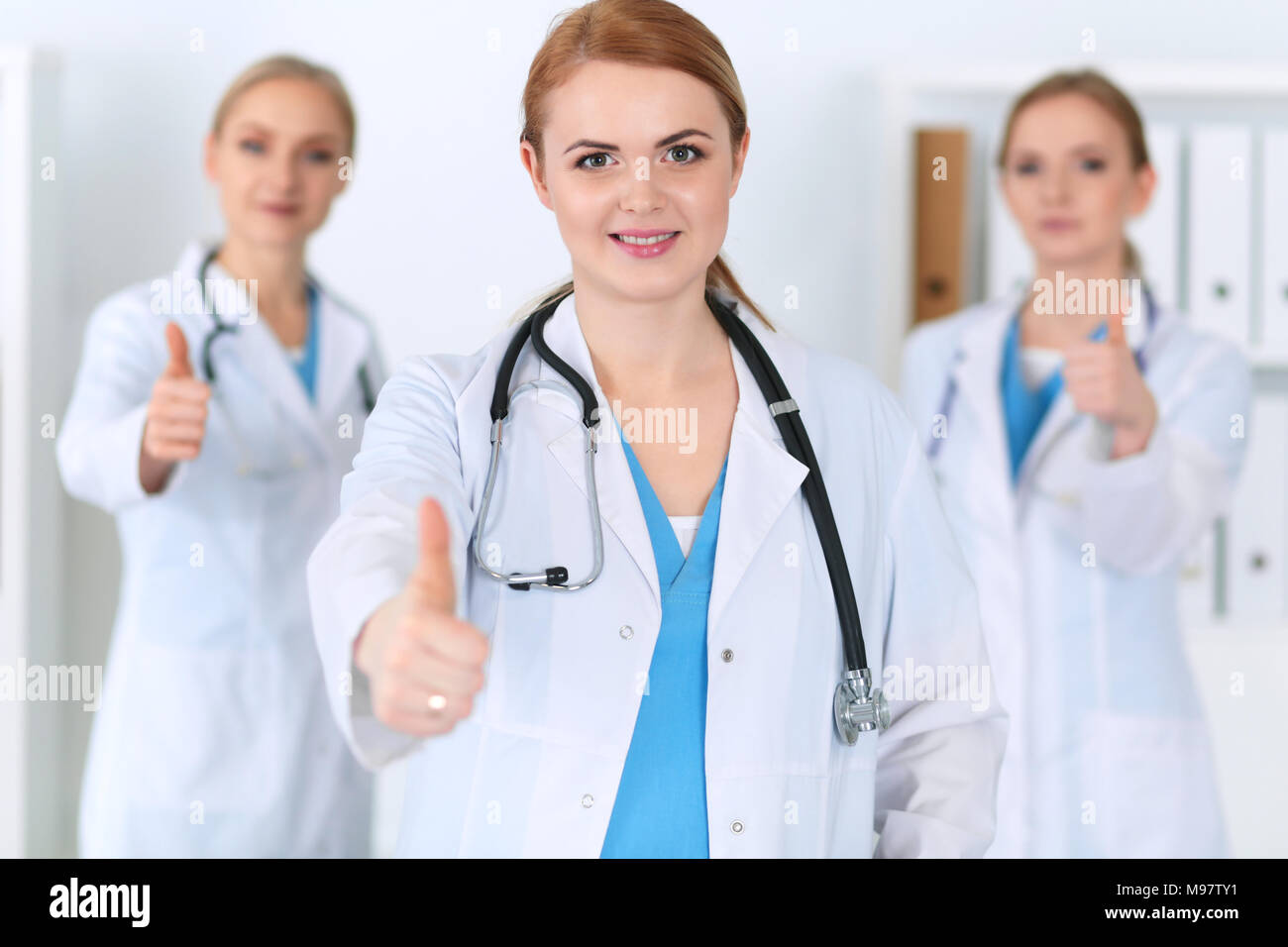 Groupe of medicine doctors show OK sign with thumb up. Success and high ...