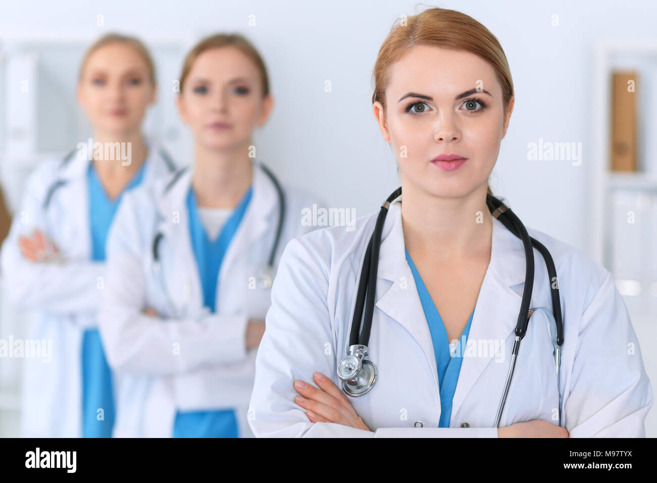 Beautiful female medical doctor standing at hospital in front of ...