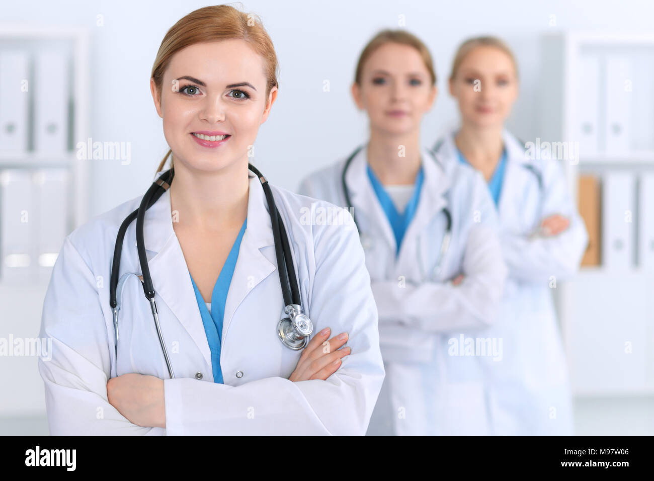 Beautiful female medical doctor standing at hospital in front of ...