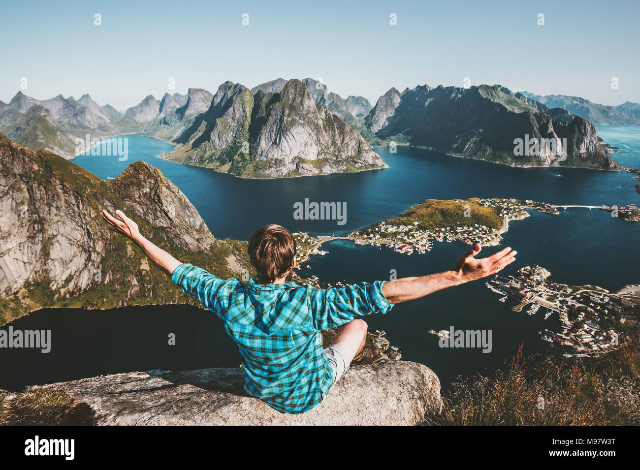 Happy Man success raised hands on cliff edge traveling in Norway ...