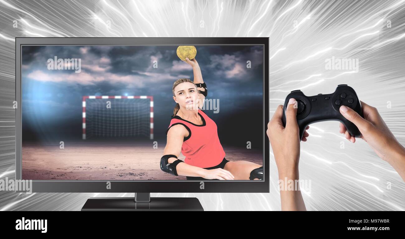 Hands holding gaming controller with handball player on television ...