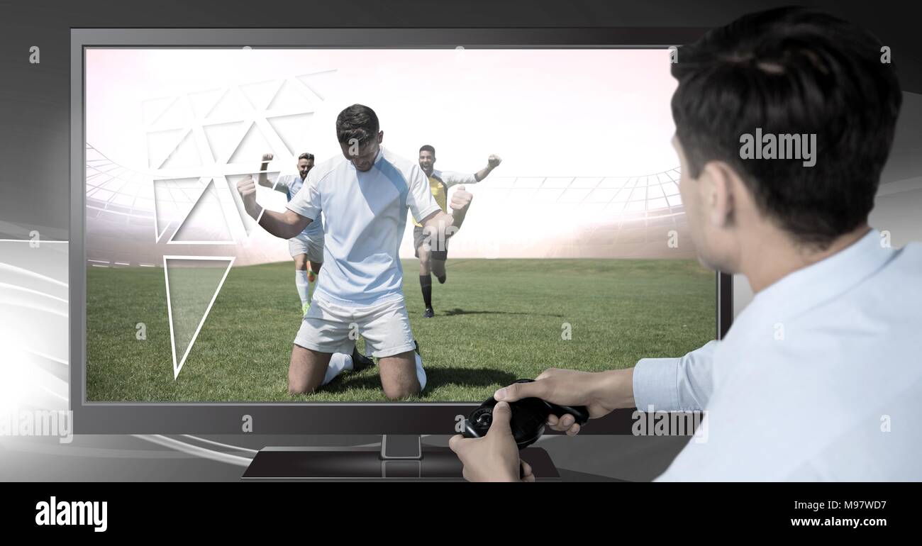 Man holding gaming controller with soccer players celebrating on ...
