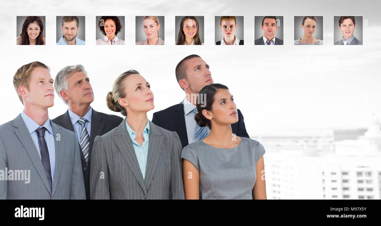 Business people looking up at portrait profiles of different people ...