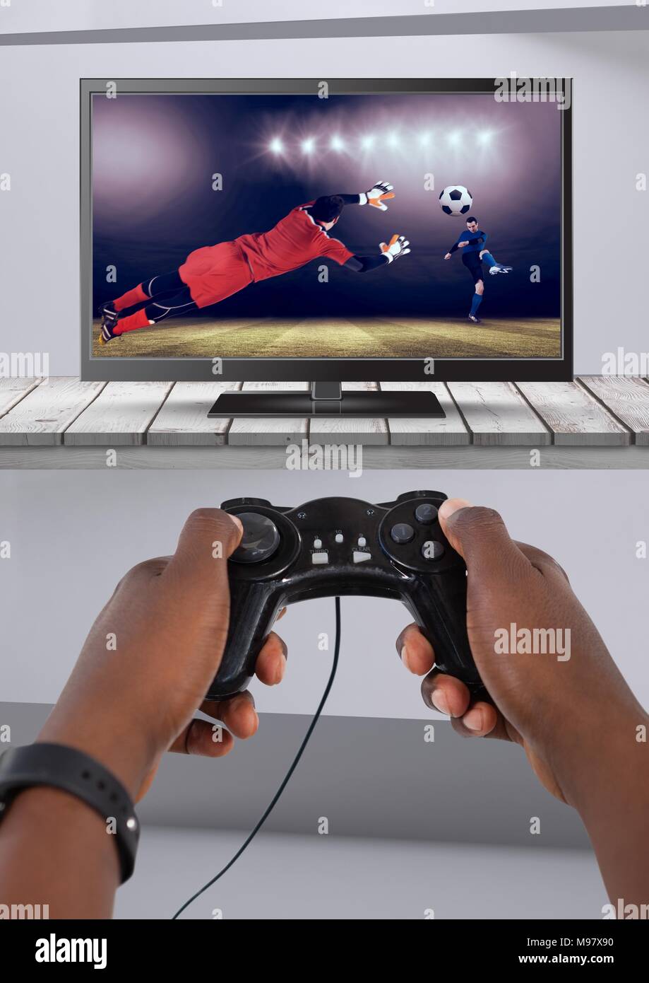 Playing soccer computer game with controller in hands Stock Photo - Alamy