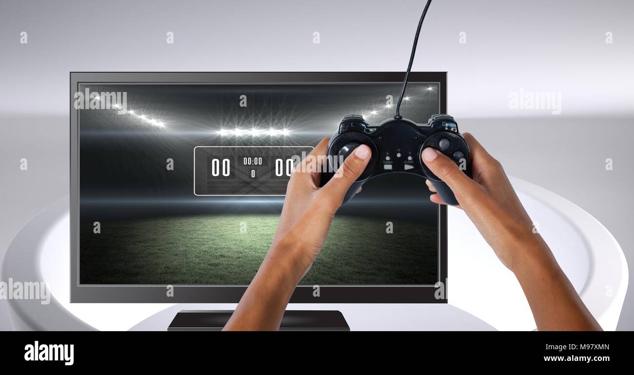 Hands holding gaming controller with sports arena stadium score on ...