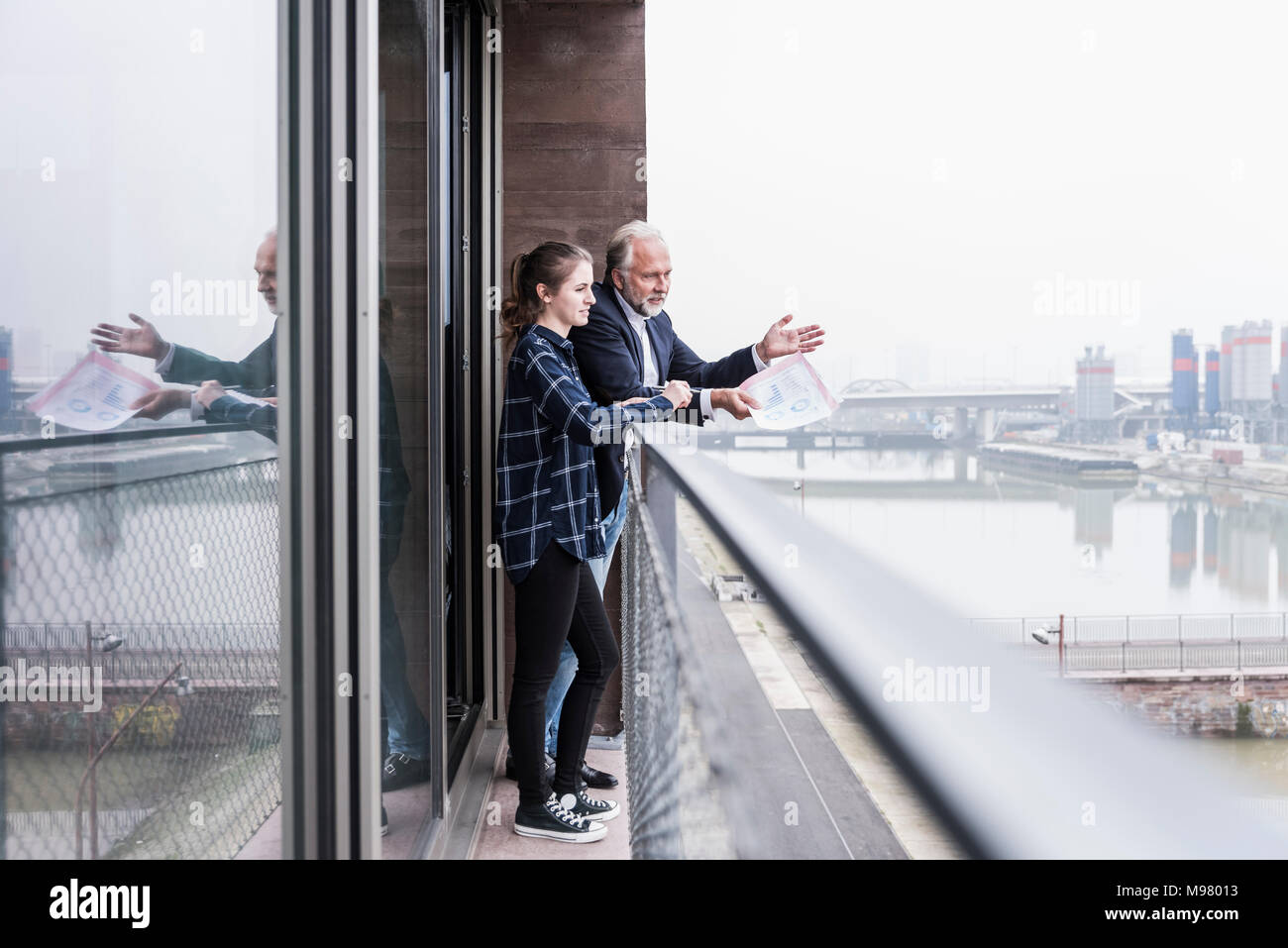 Two people talking on balcony hi-res stock photography and images - Alamy