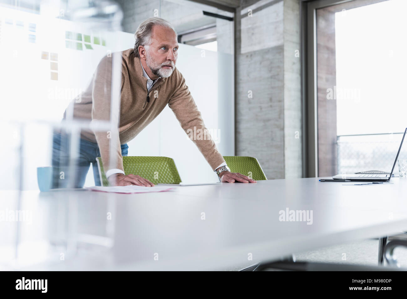 Leaning over table in hi-res stock photography and images - Alamy