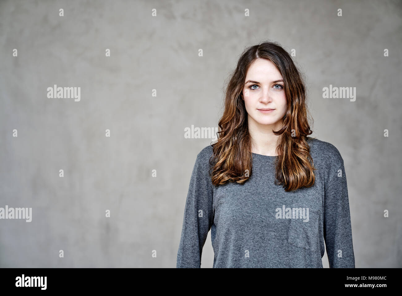 Young woman in grey hi-res stock photography and images - Alamy