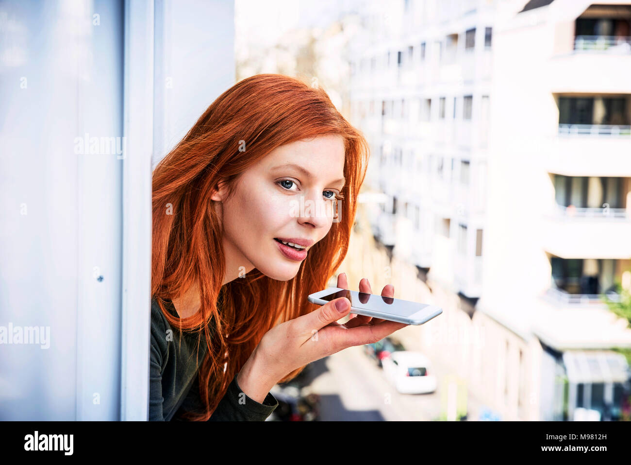 Leaning out of window exterior hi-res stock photography and images - Alamy