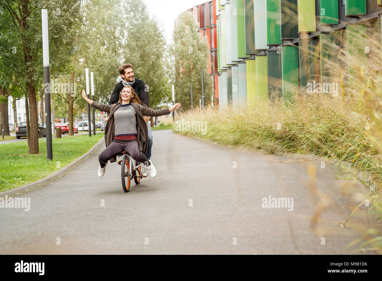 Couple riding one bike hi-res stock photography and images - Alamy