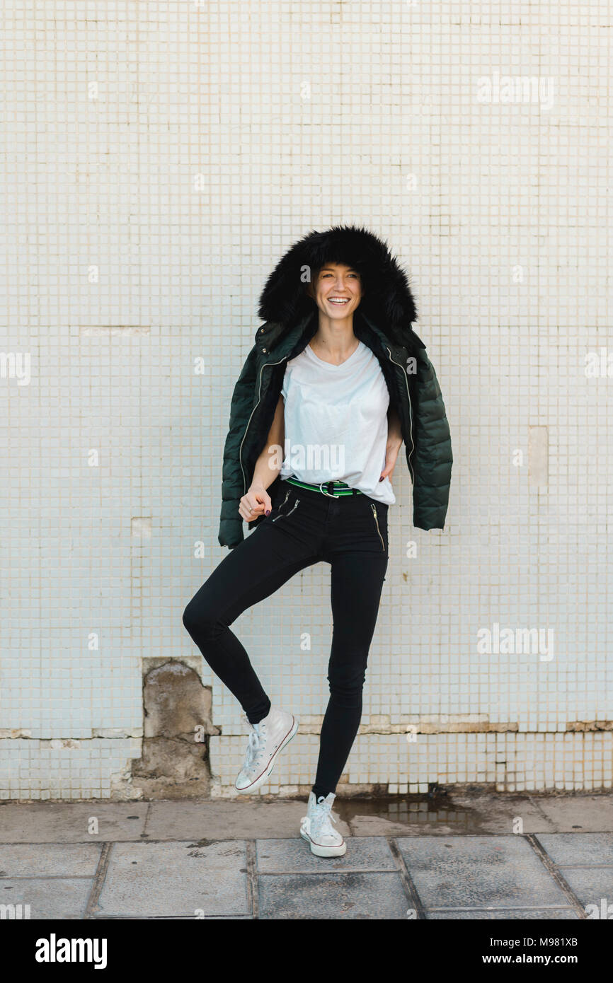 Laughing woman wearing hooded jacket Stock Photo - Alamy