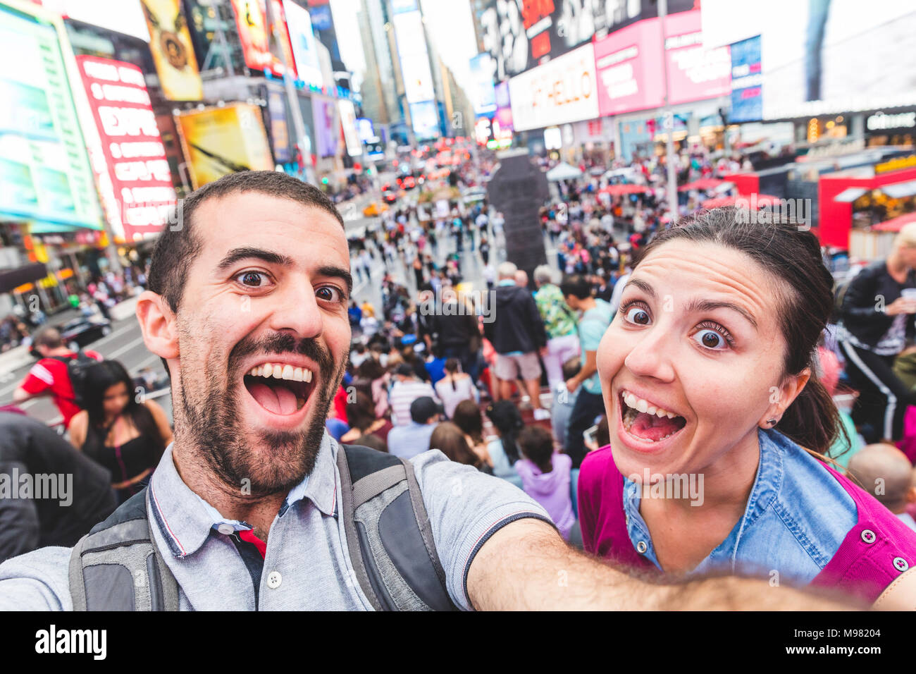 Selfie of happy couple in the city at times square hi-res stock ...