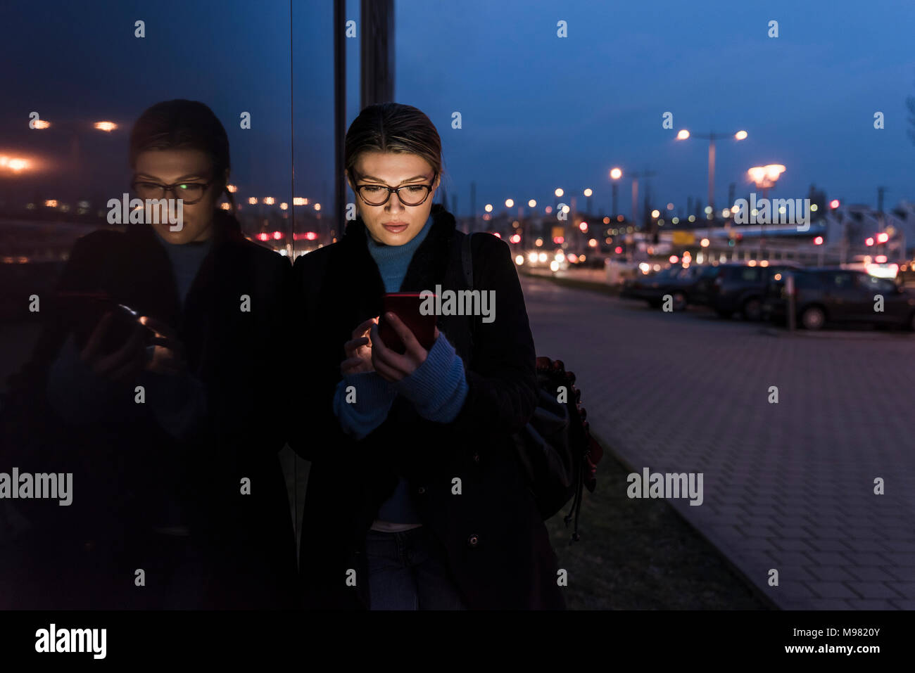 Woman leaning against glass window hi-res stock photography and images ...