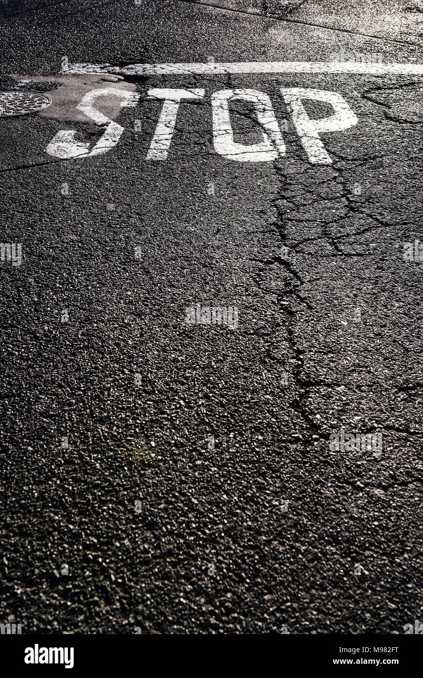 'Stop' sign on tarmac Stock Photo - Alamy