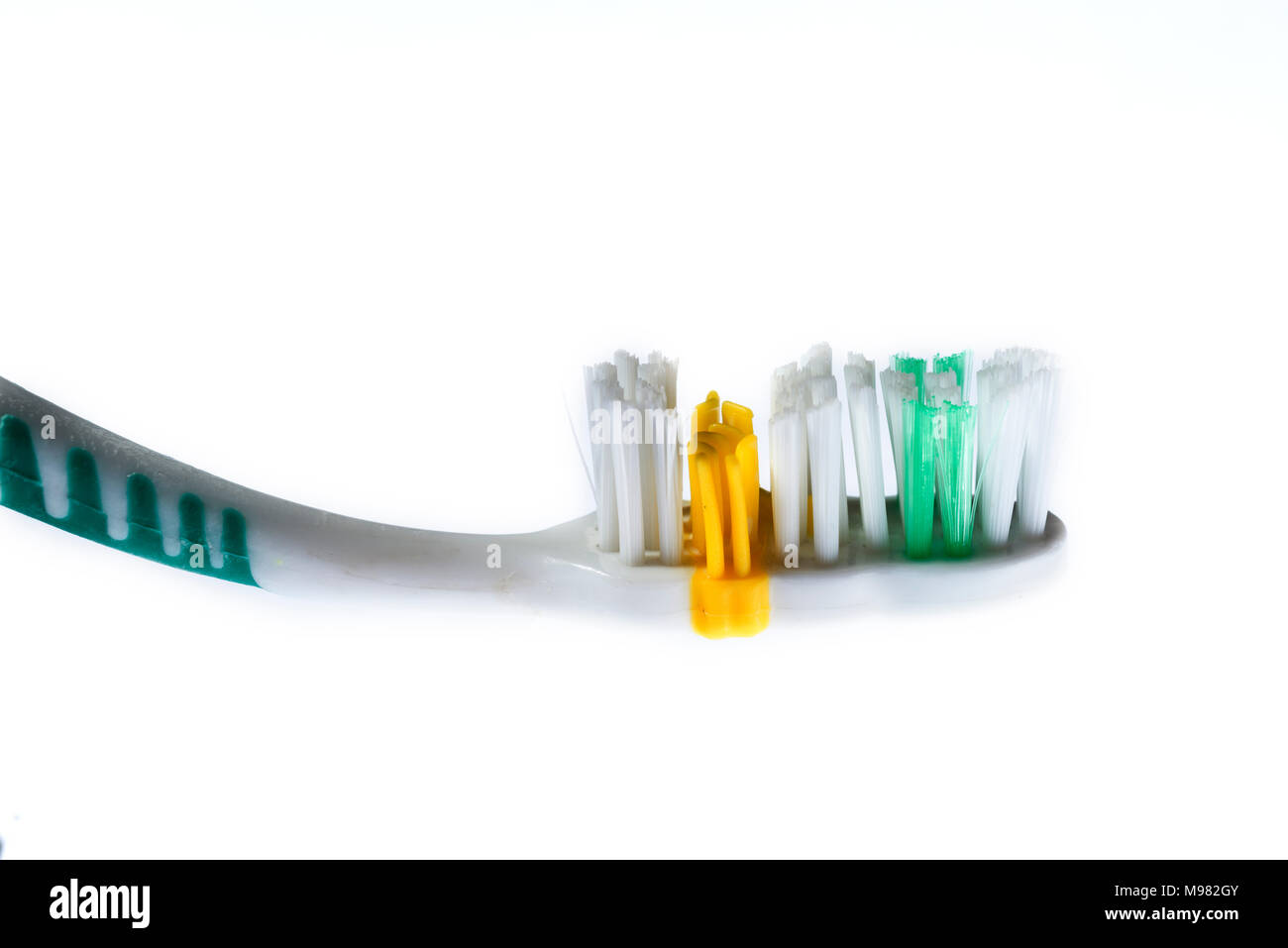 toothbrush of different colors on white background Stock Photo - Alamy
