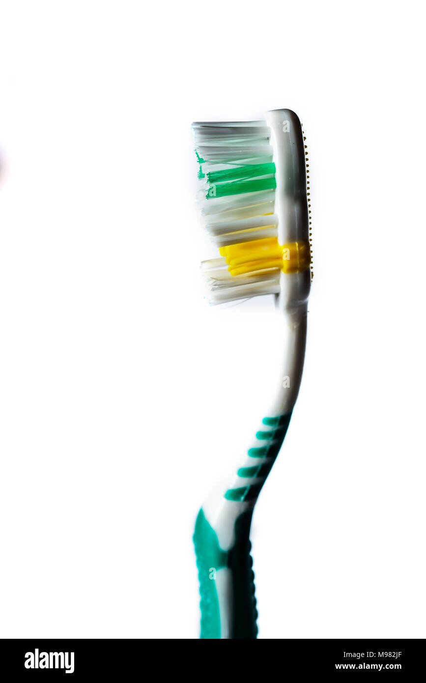 toothbrush of different colors on white background Stock Photo - Alamy