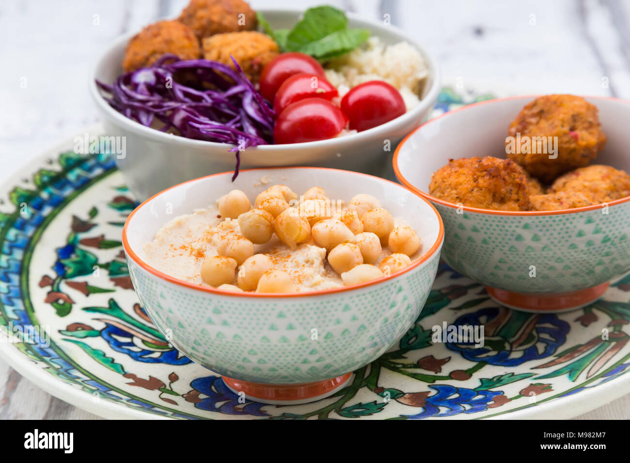 Hummus, sweet potato balls, Couscous and vegetables in bowls Stock ...