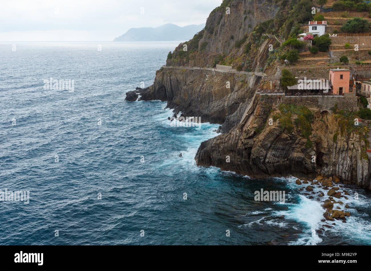 Beautiful surf waves and rocky coast in summer Manarola outskirts - one ...