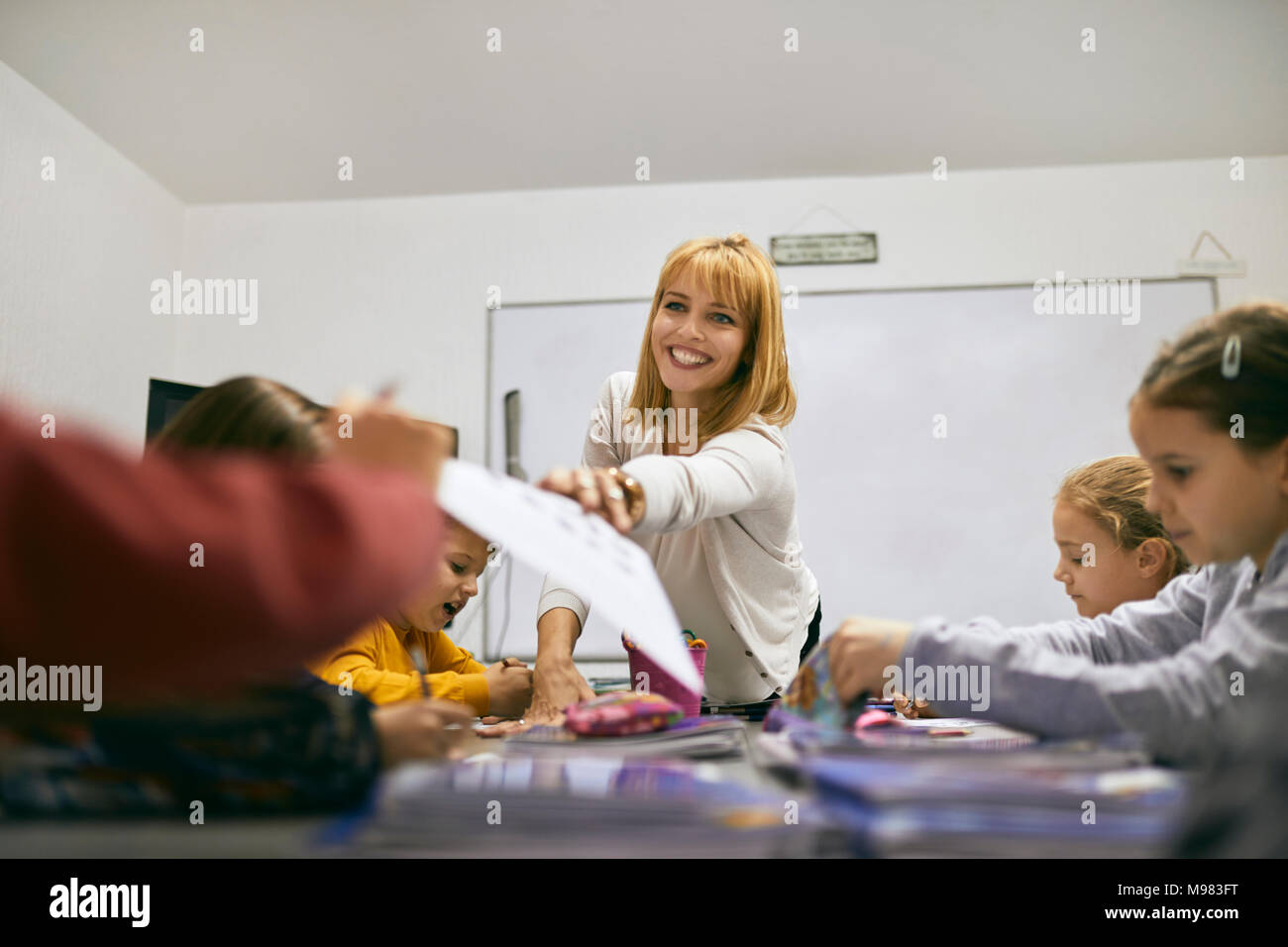 Handing over paper school hi-res stock photography and images - Alamy