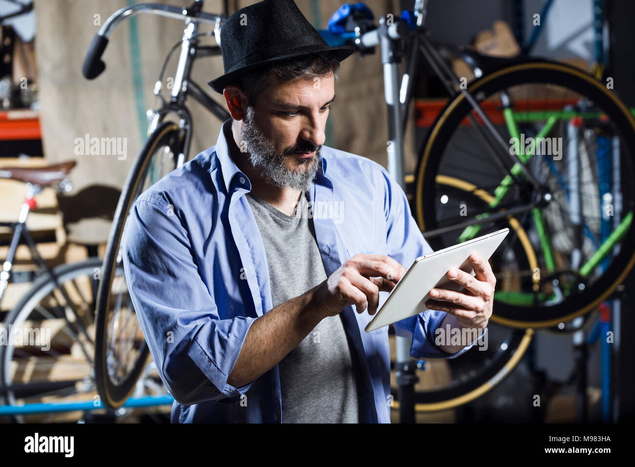 Man in bicycle shop hi-res stock photography and images - Alamy