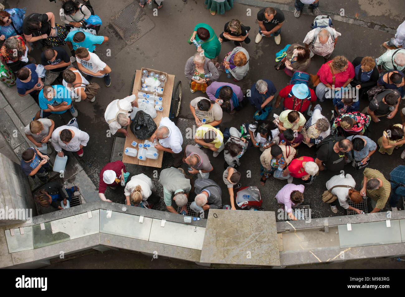 Lourdes. Faithful at the fountains of holy water. France Stock Photo ...