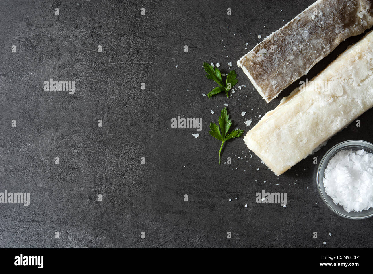 Salted dried cod on black stone top view. Typical Easter food Stock ...