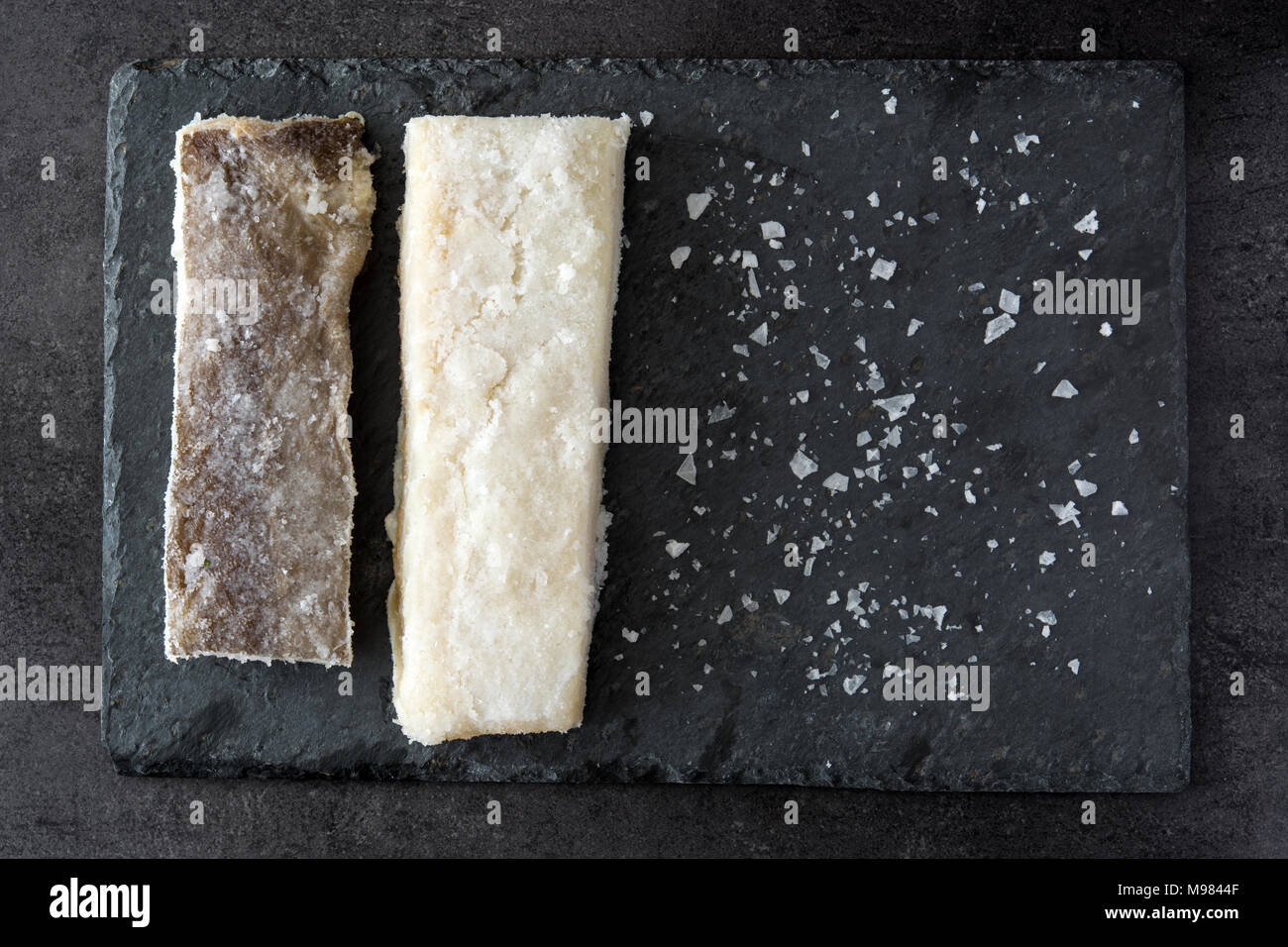 Salted dried cod on black stone top view. Typical Easter food Stock ...