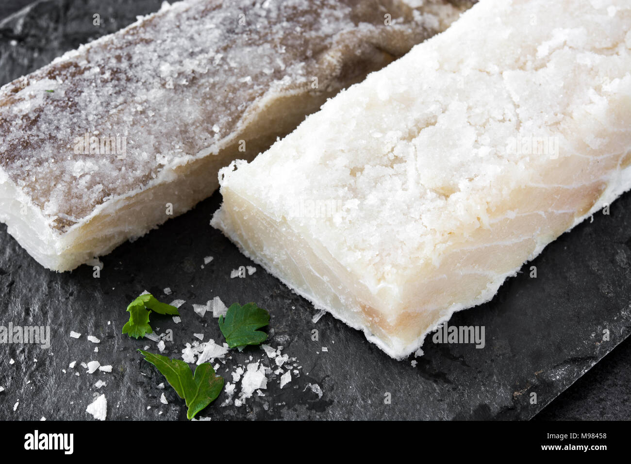 Salted dried cod on black stone top view. Typical Easter food Stock ...