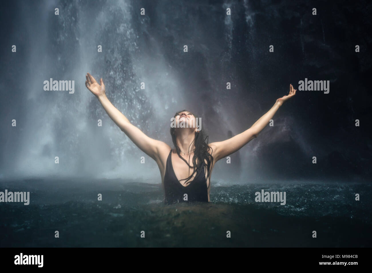 Young woman bathing at sekumpul waterfall hi-res stock photography and ...