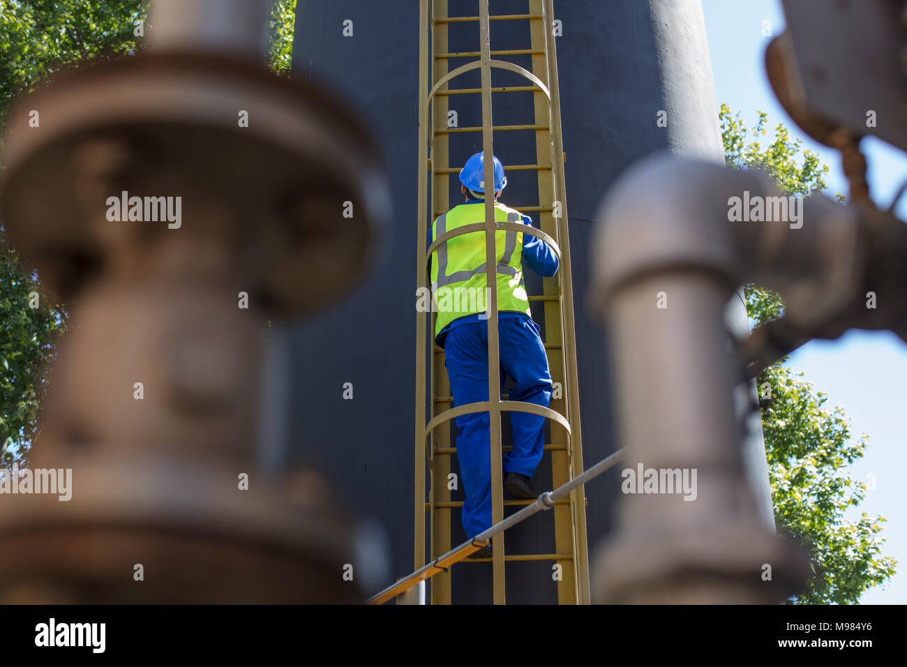 South Africa, Cape town, Construction worker climbing up ladder Stock ...