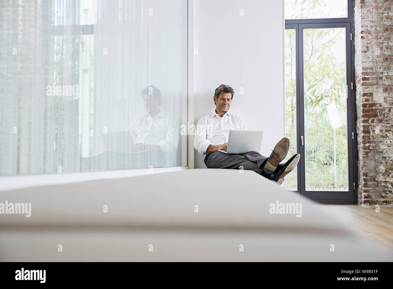 Man sitting feet bench hi-res stock photography and images - Alamy
