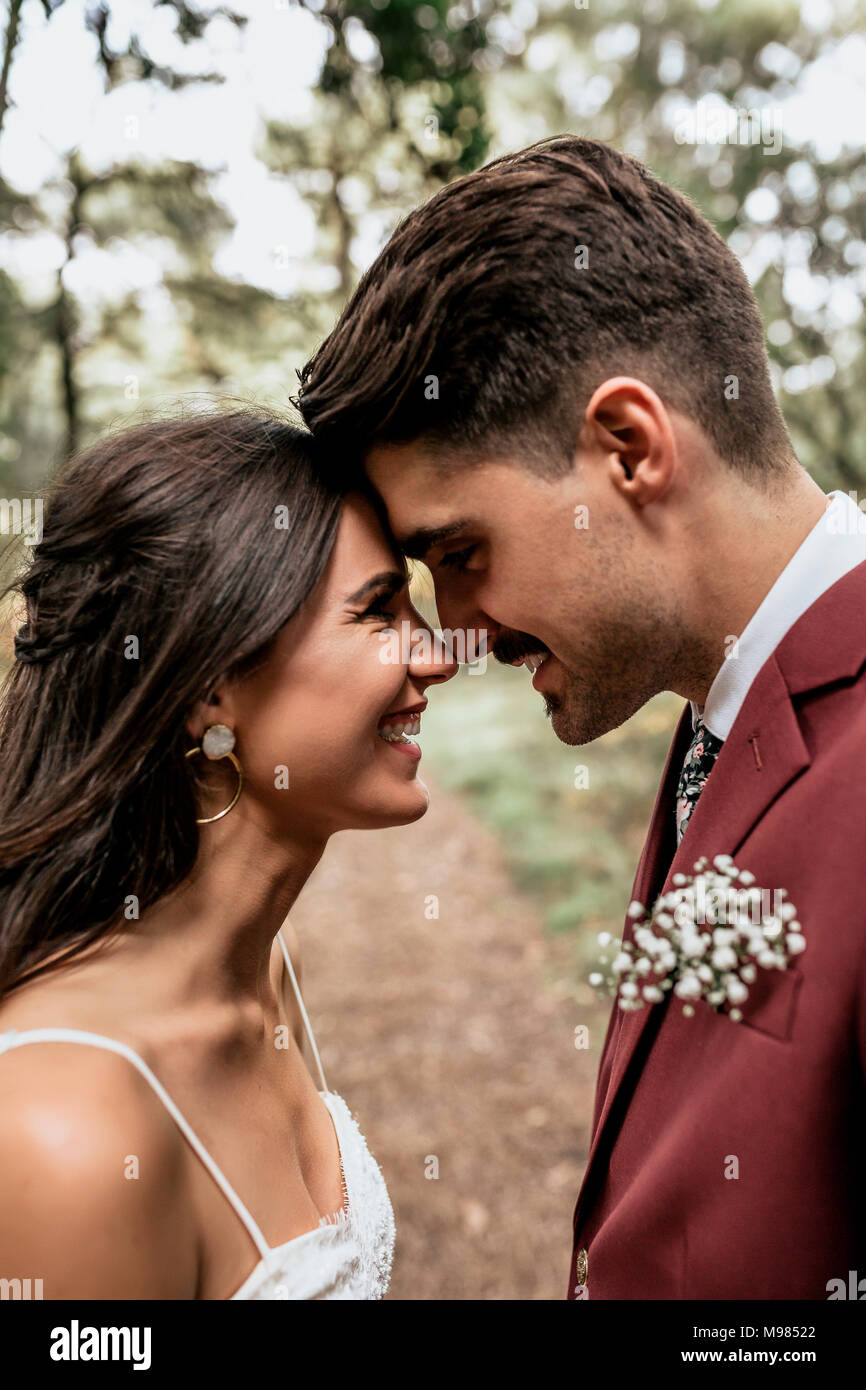 Happy wedding couple head to head looking at each other Stock Photo - Alamy