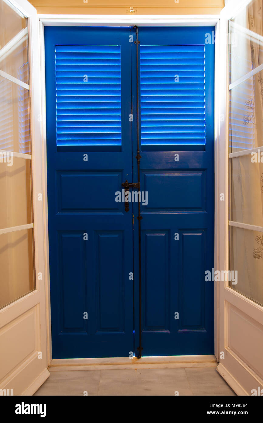 Blue door and window with shutters Stock Photo - Alamy
