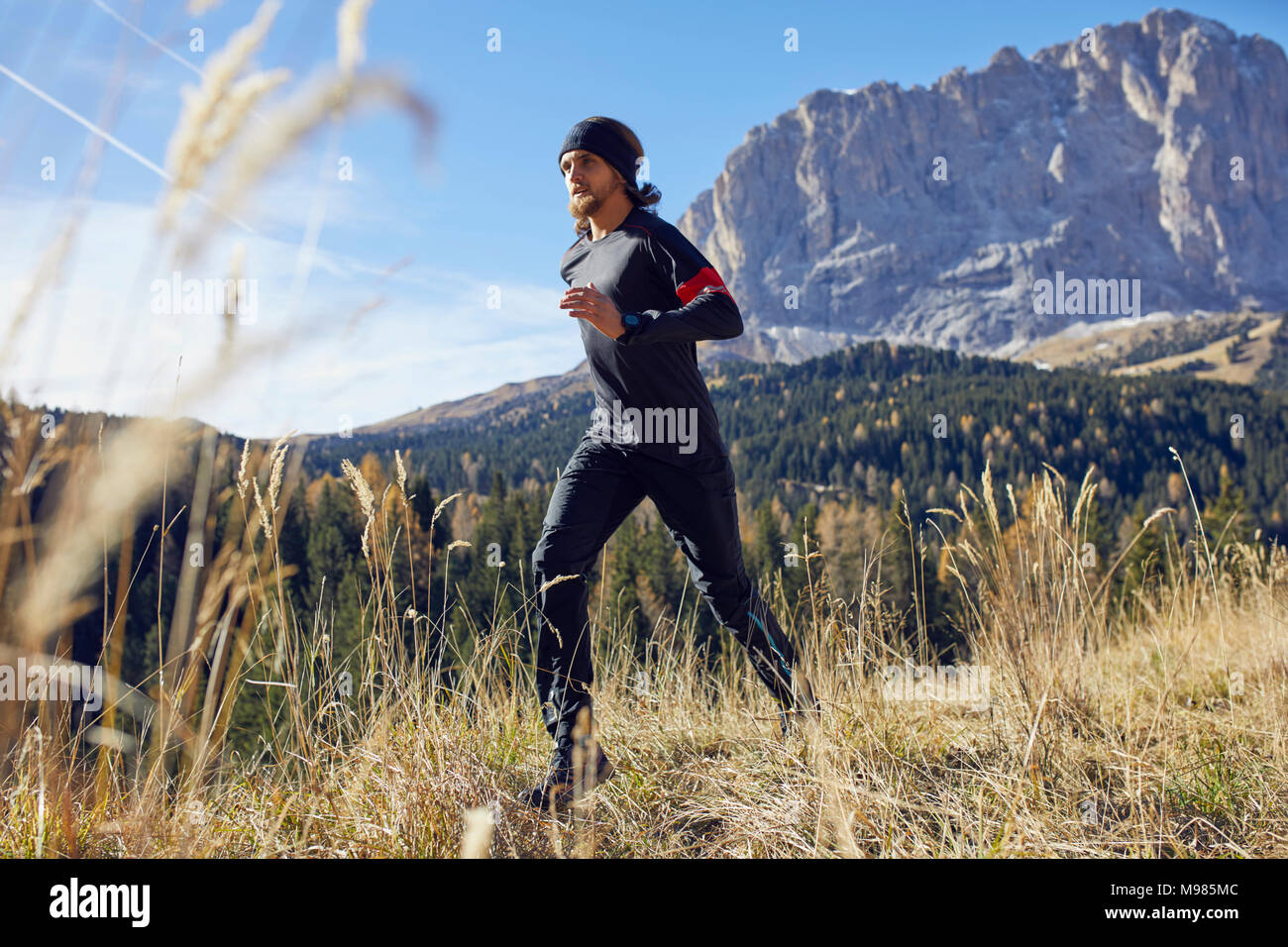 Man running on mountain trail Stock Photo - Alamy