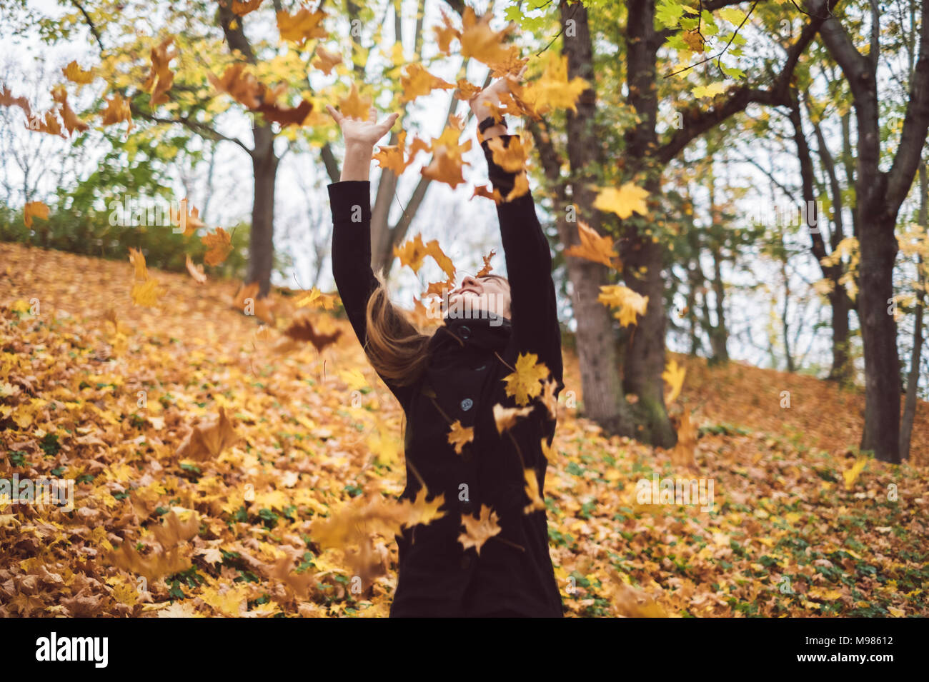 Woman throwing leaves up hi-res stock photography and images - Alamy