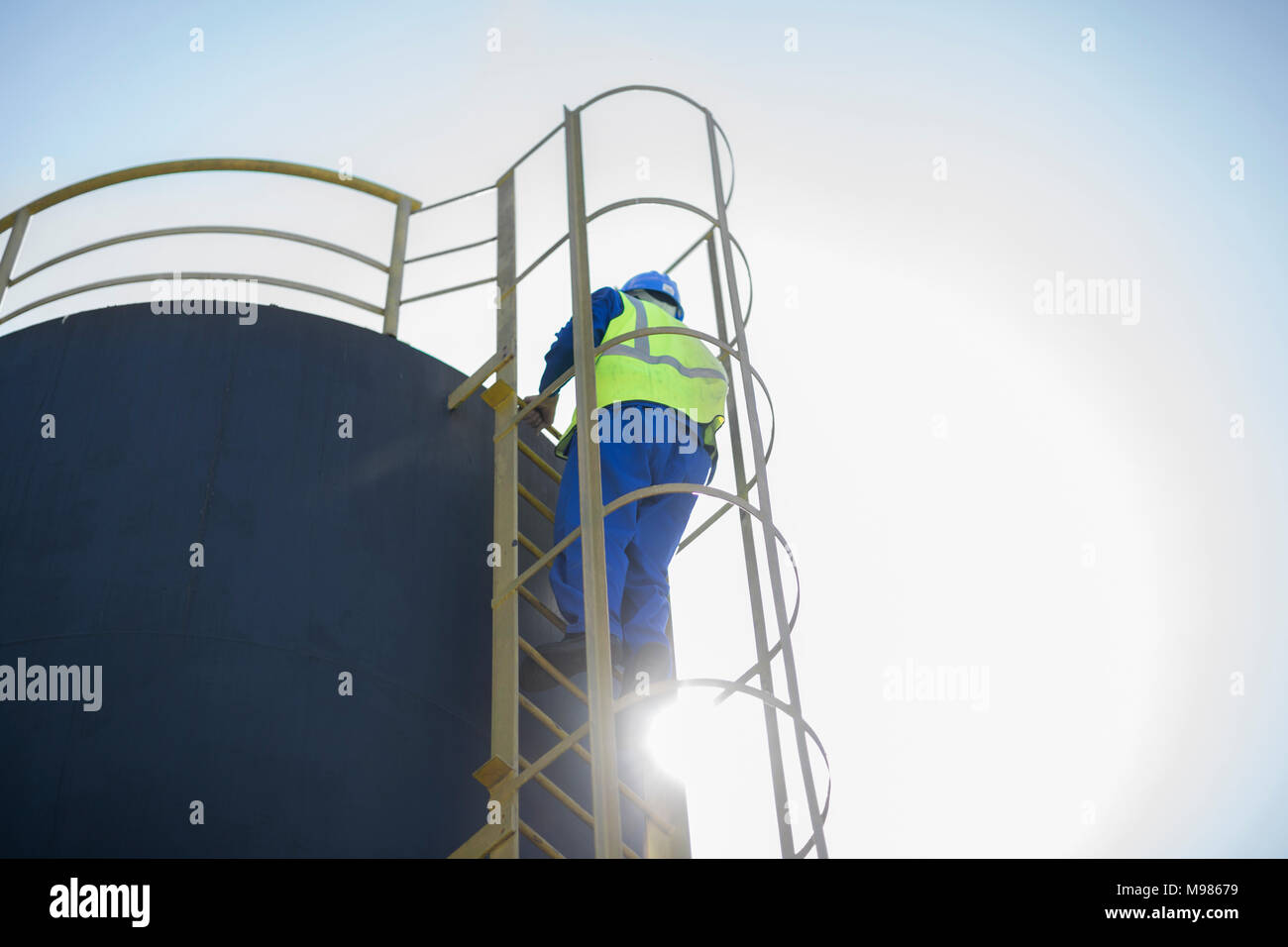 South Africa, Cape town, Construction worker climbing up ladder Stock ...