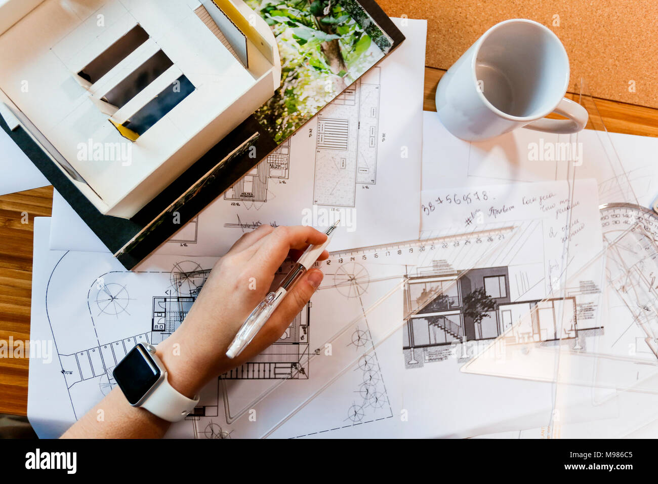 Hand of young architect worcing on a blueprint Stock Photo - Alamy