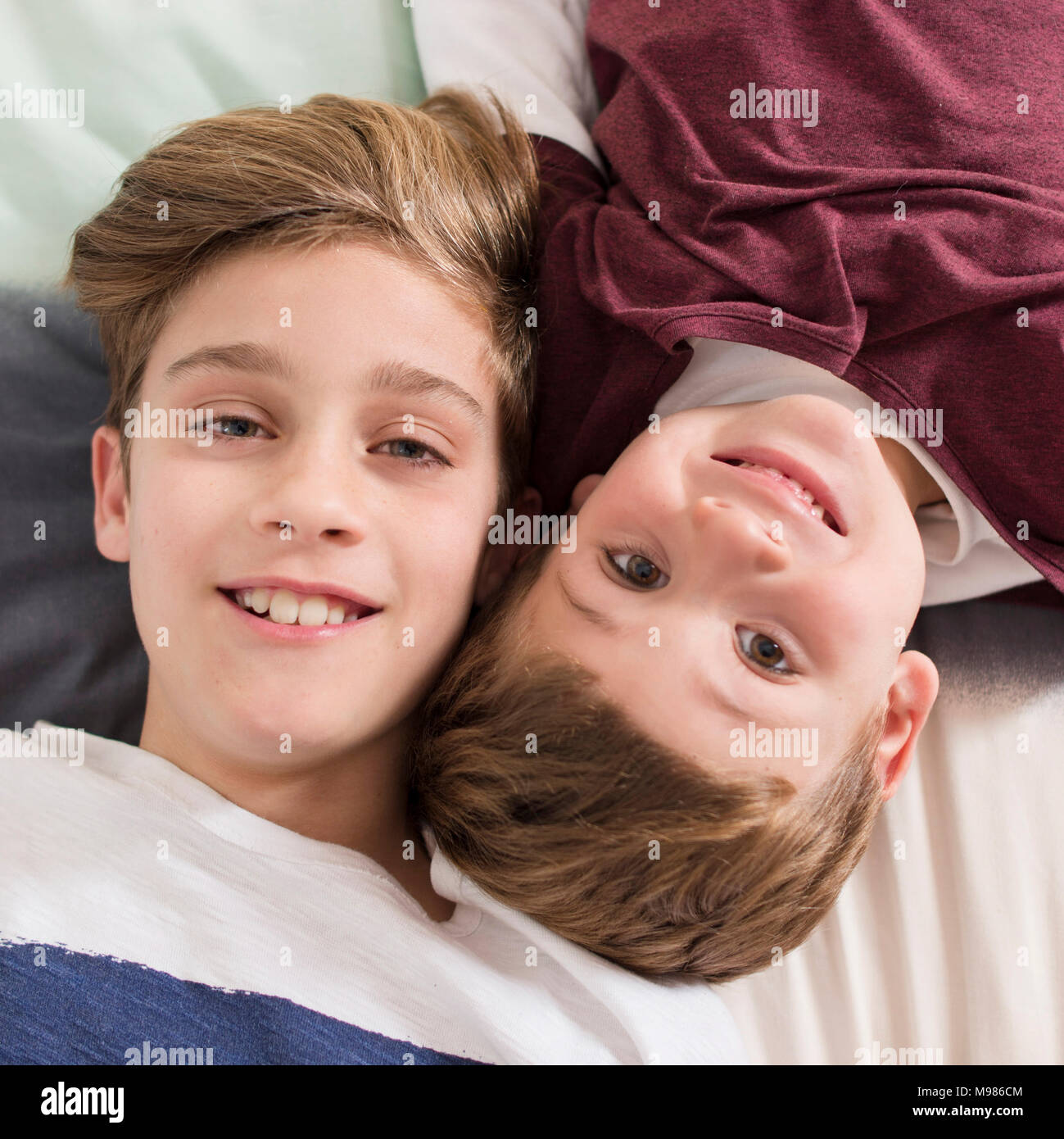 Two lying laughing brothers hi-res stock photography and images - Alamy