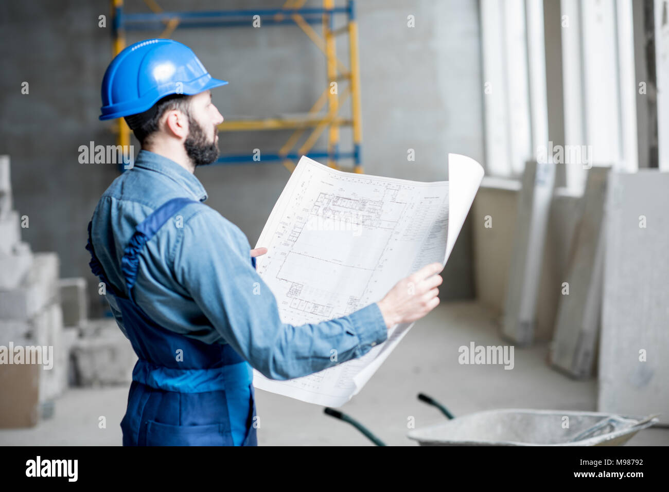 Builder at the construction site Stock Photo - Alamy