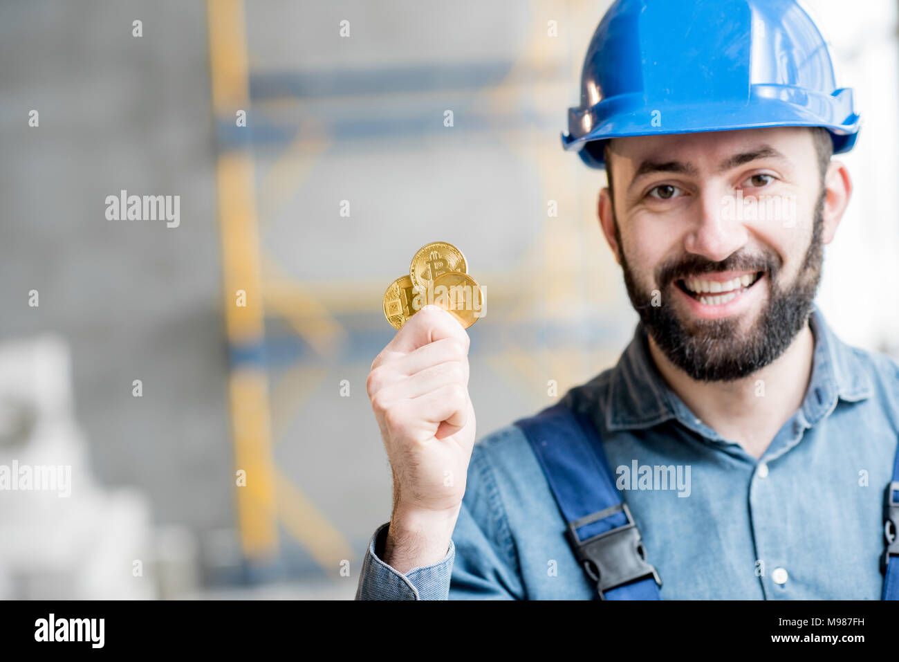 Builder with cryptocoin Stock Photo - Alamy