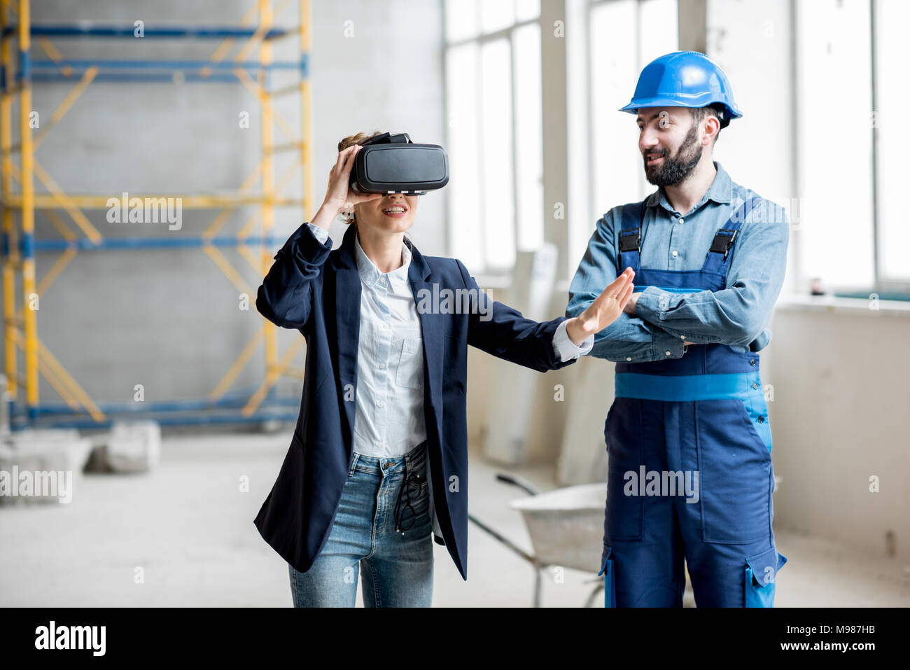 Woman client wearing VR glasses at the construction site Stock Photo ...