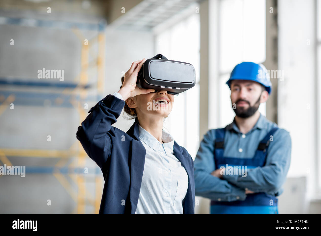 Woman client wearing VR glasses at the construction site Stock Photo ...