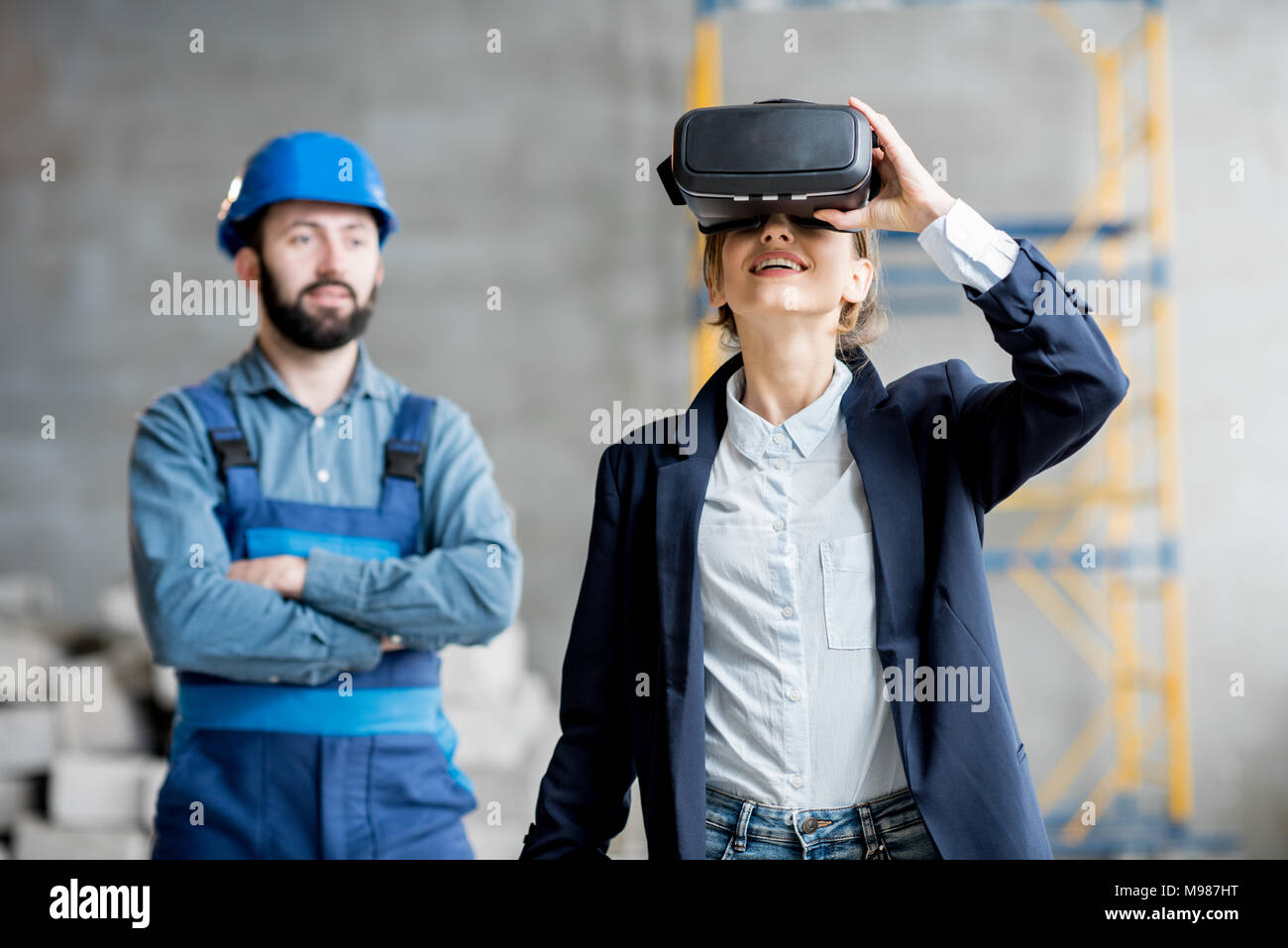 Woman client wearing VR glasses at the construction site Stock Photo ...