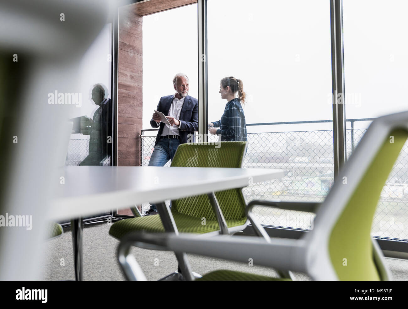 Two people talking on balcony hi-res stock photography and images - Alamy