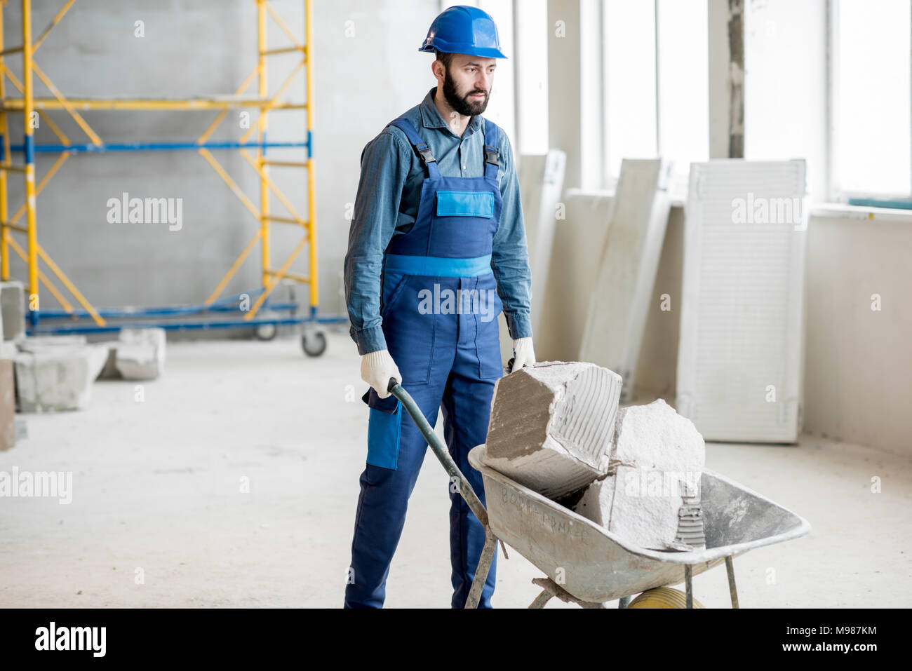 Carrying blocks on a wheelbarrow Stock Photo - Alamy