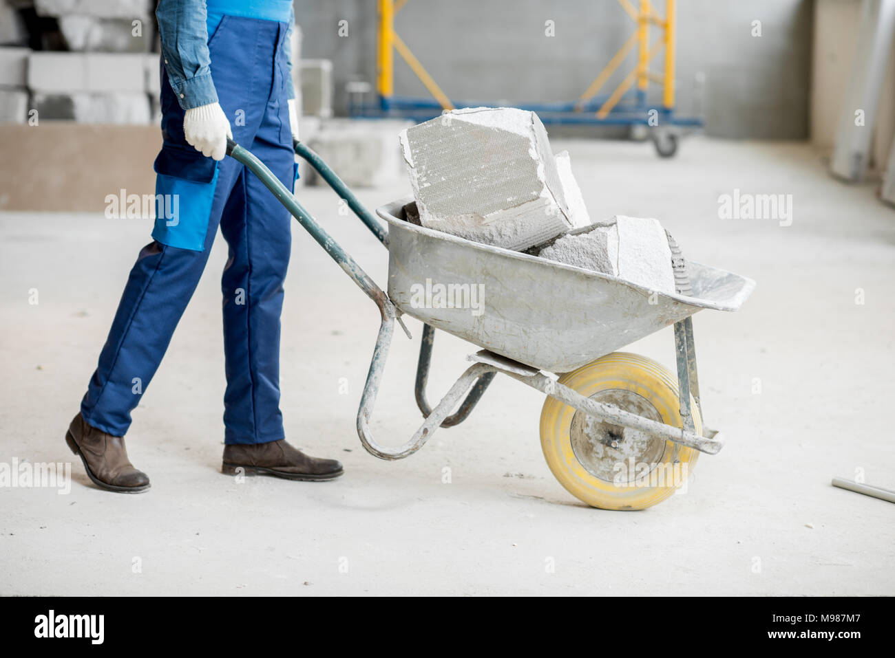 Carrying blocks on a wheelbarrow Stock Photo - Alamy