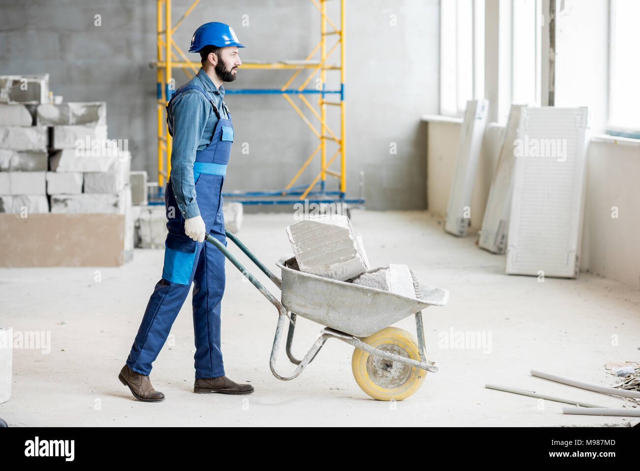 Man carrying heavy brick hi-res stock photography and images - Alamy