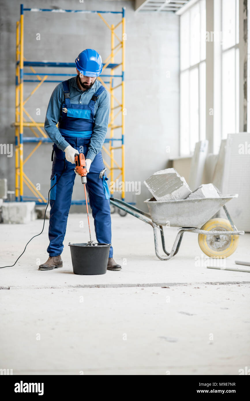 Builder mixing plaster construction hi-res stock photography and images ...