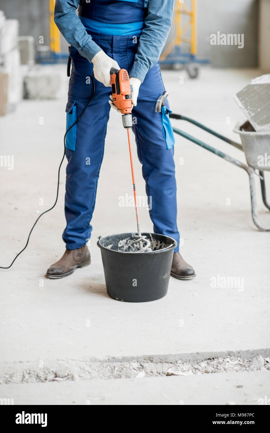 Builder mixing plaster at the construction site Stock Photo - Alamy